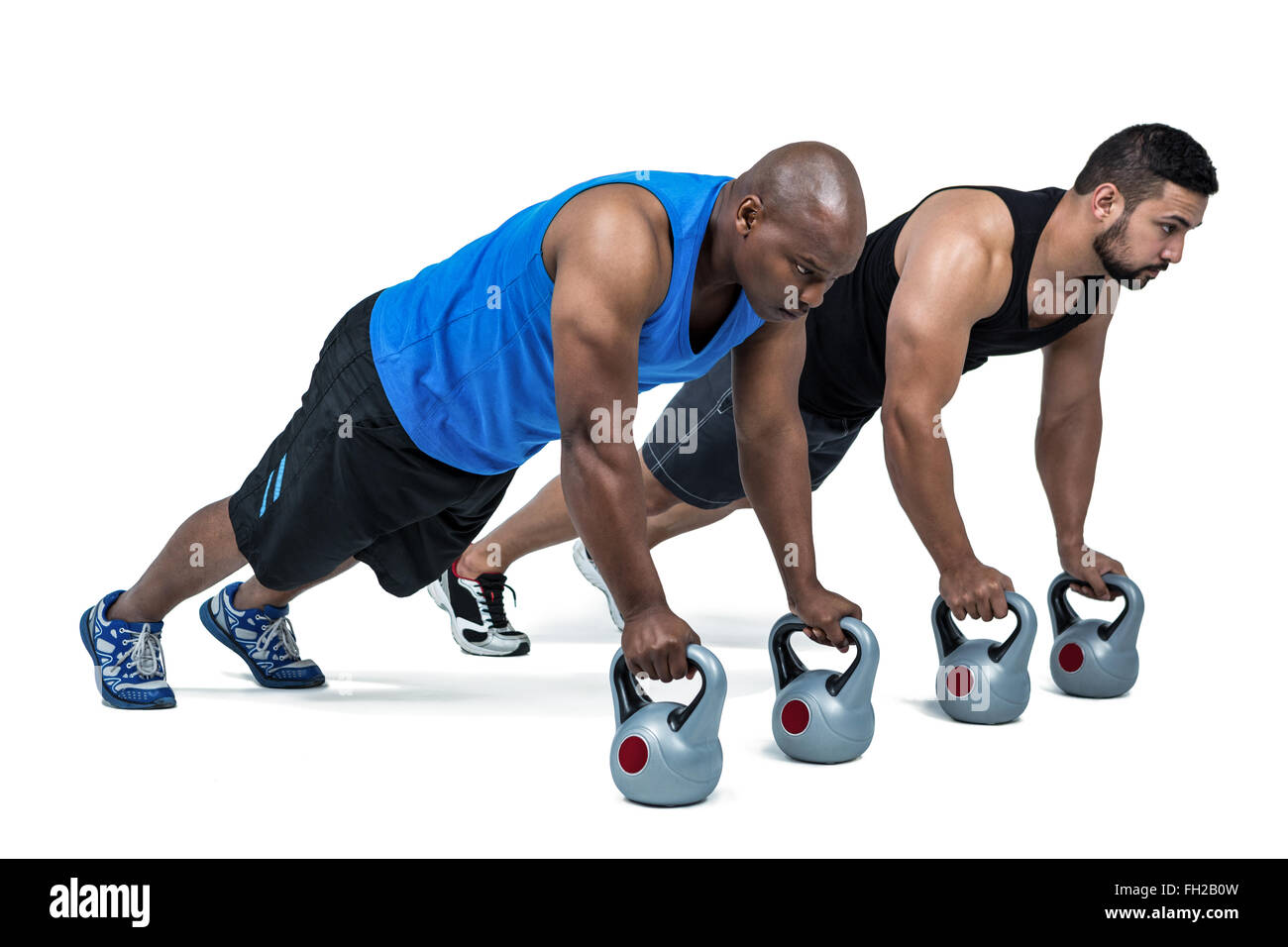 Strong friends using kettlebells together Stock Photo - Alamy