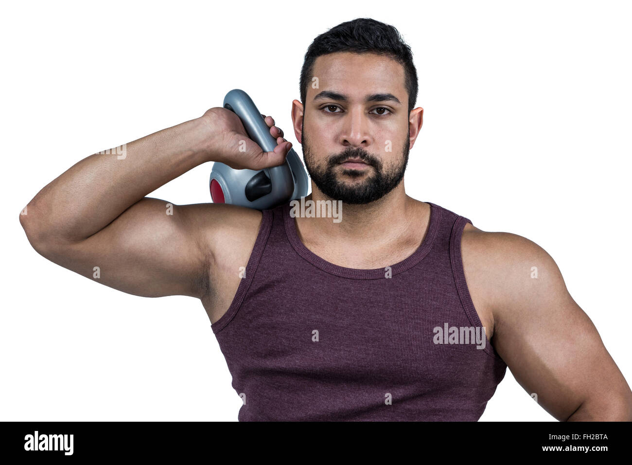 Muscular serious man holding a kettlebell Stock Photo - Alamy