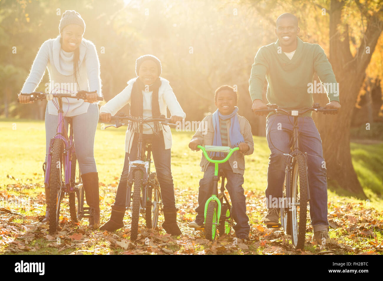 Young smiling family doing a bike ride Stock Photo - Alamy