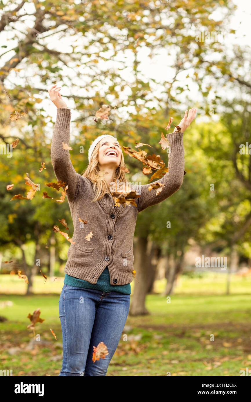Smiling woman throwing leaves hi-res stock photography and images - Alamy