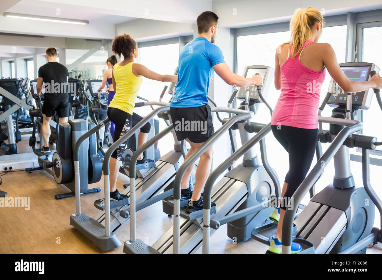 Fit people working out using machines Stock Photo - Alamy