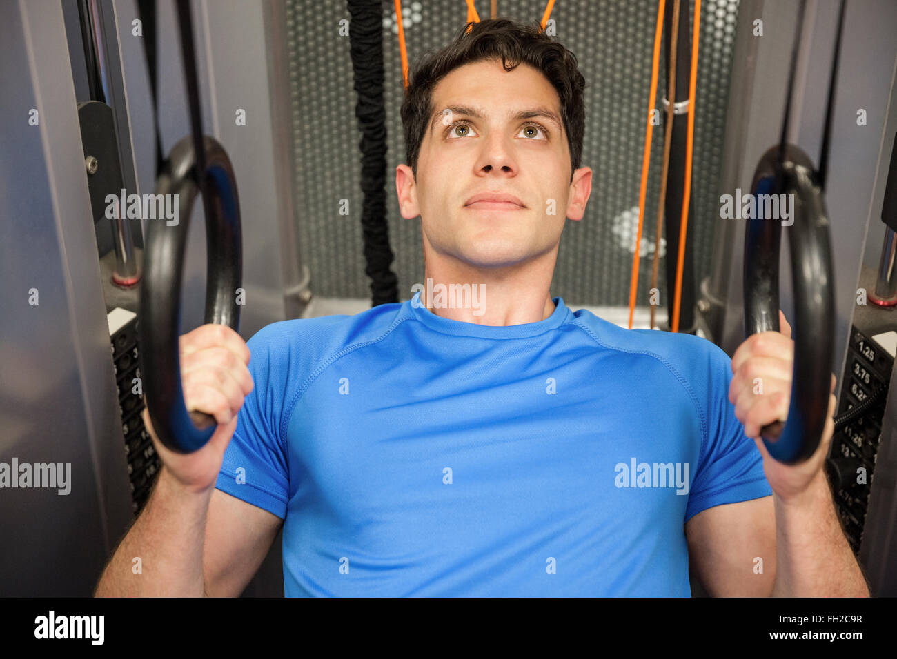 Man pulling himself up with the rings in hand Stock Photo - Alamy