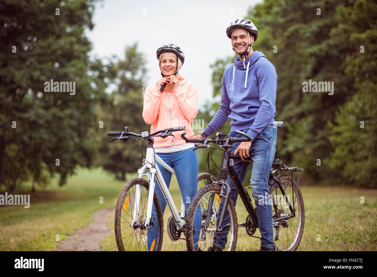 Happy couple on a bike ride Stock Photo - Alamy