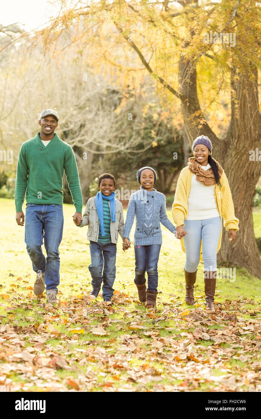 Portrait of a young smiling family walking Stock Photo - Alamy