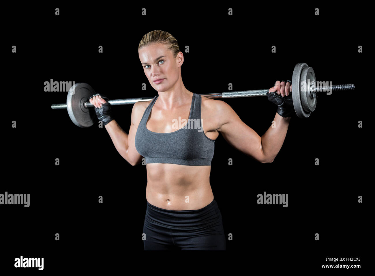 Muscular woman lifting heavy barbell Stock Photo - Alamy