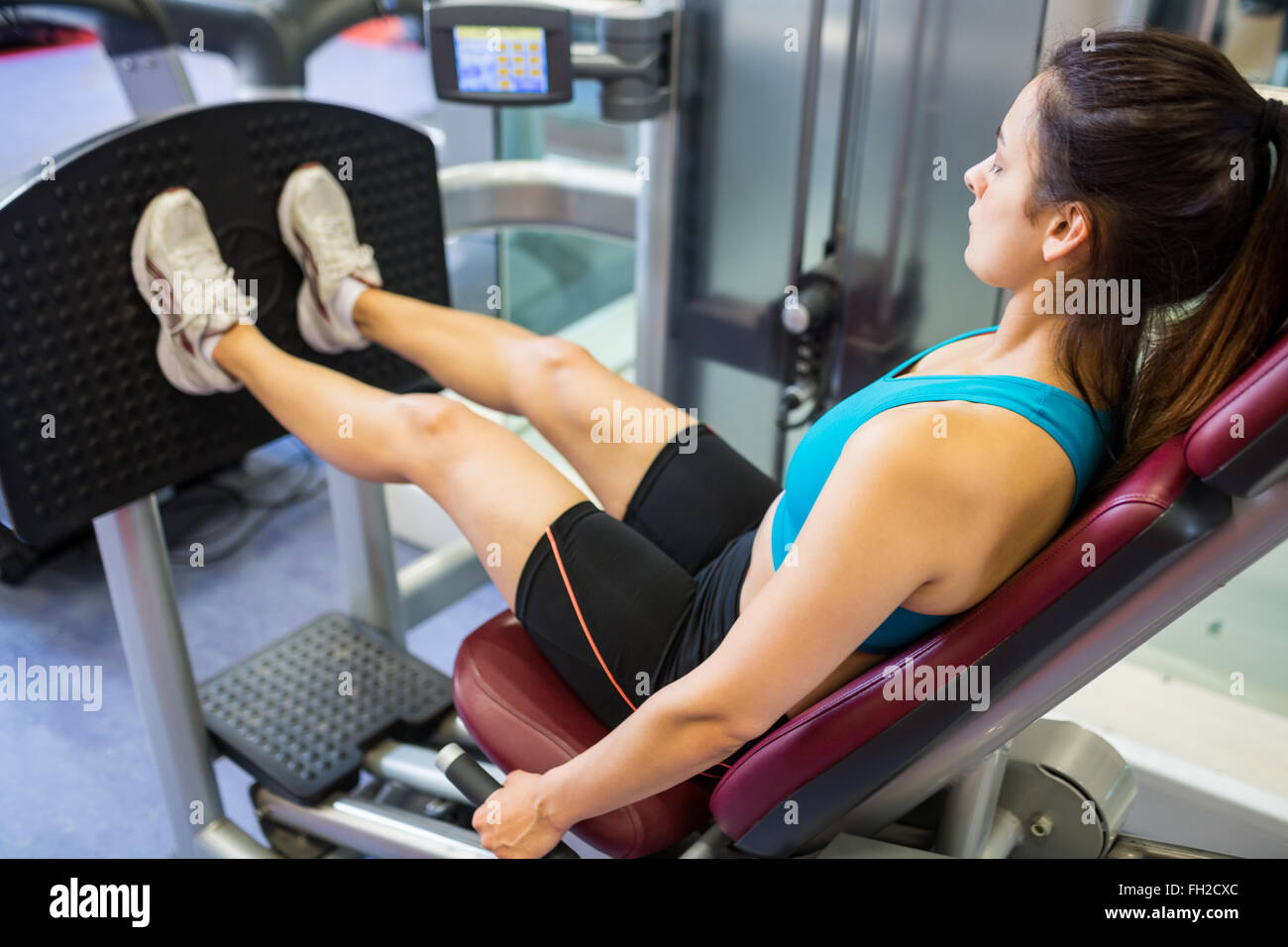 Focused woman doing leg training Stock Photo - Alamy