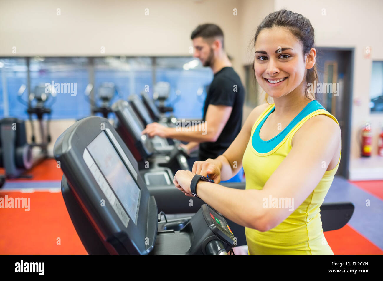 Couple using treadmills together Stock Photo - Alamy