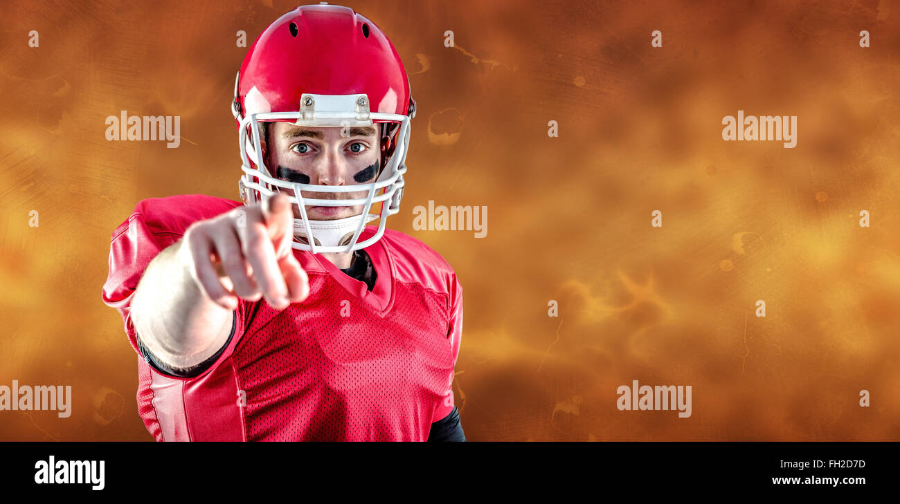 Composite image of portrait of american football player pointing to ...