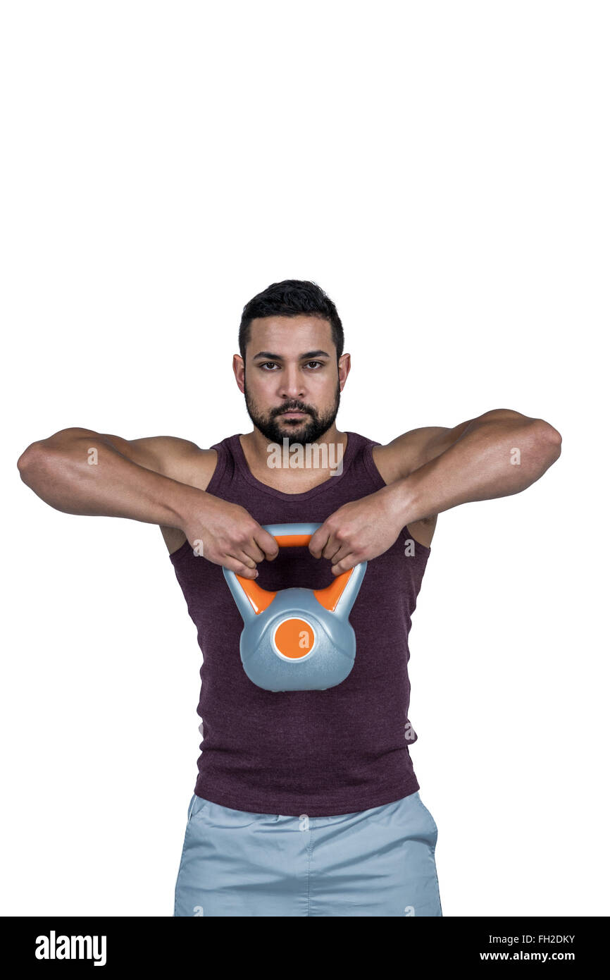 Muscular serious man lifting a kettlebell Stock Photo - Alamy