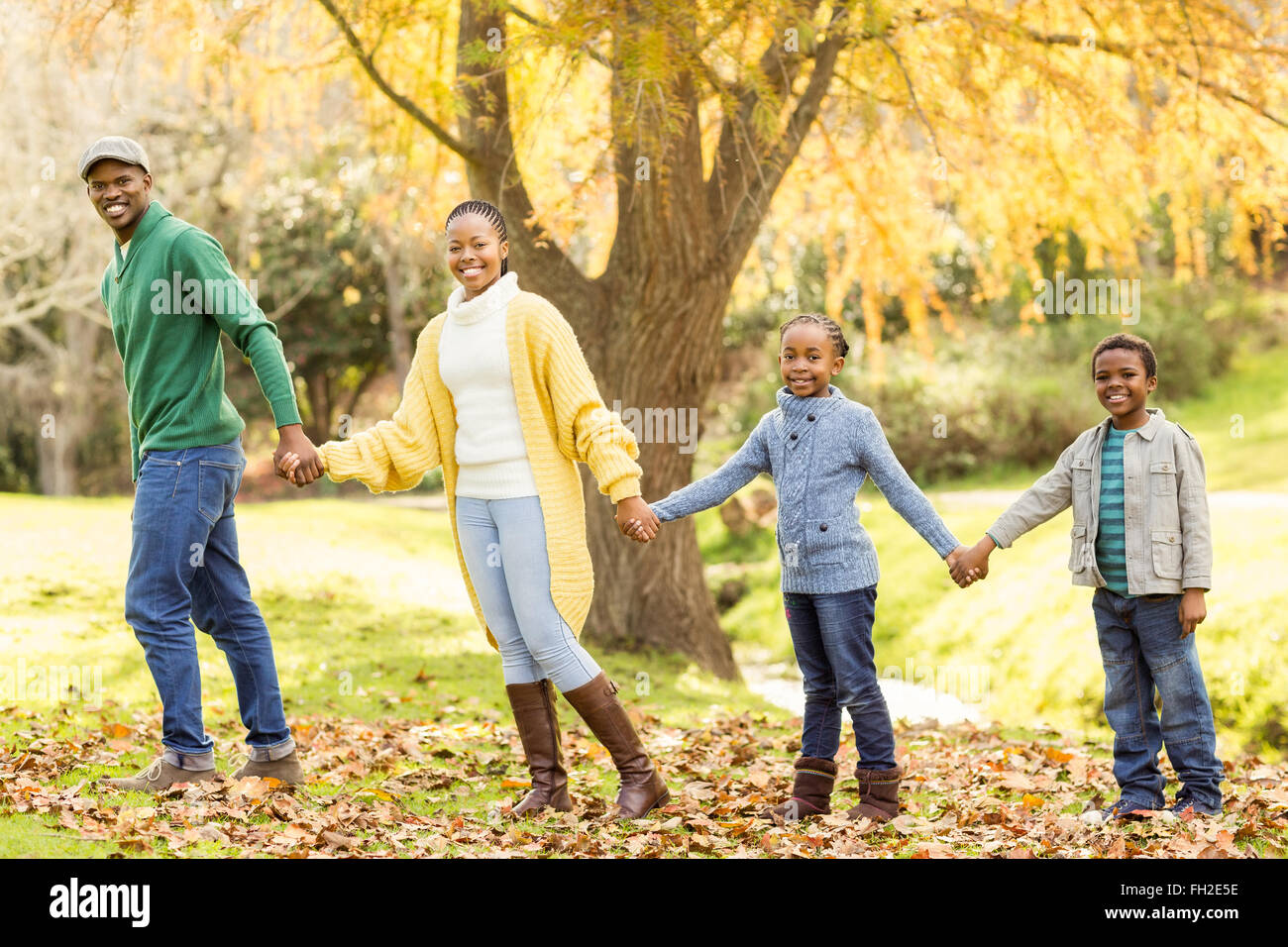 Young smiling family giving their hands to others Stock Photo - Alamy