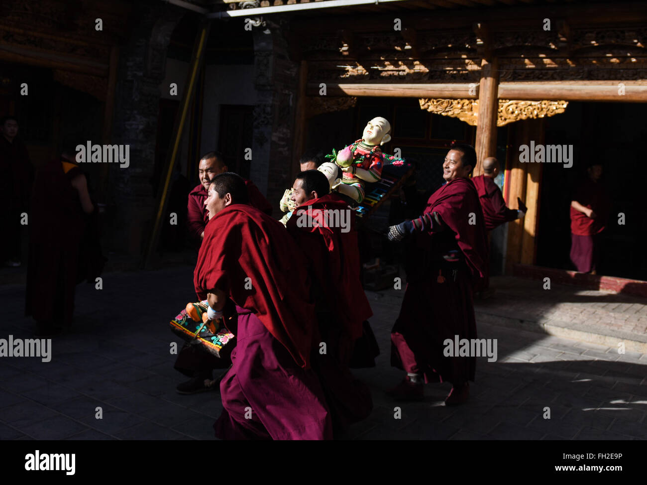 Xining. 22nd Feb, 2016. Buddhists move butter sculptures to a platform ...
