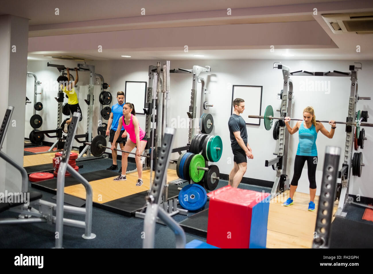 Fit people working out in weights room Stock Photo - Alamy