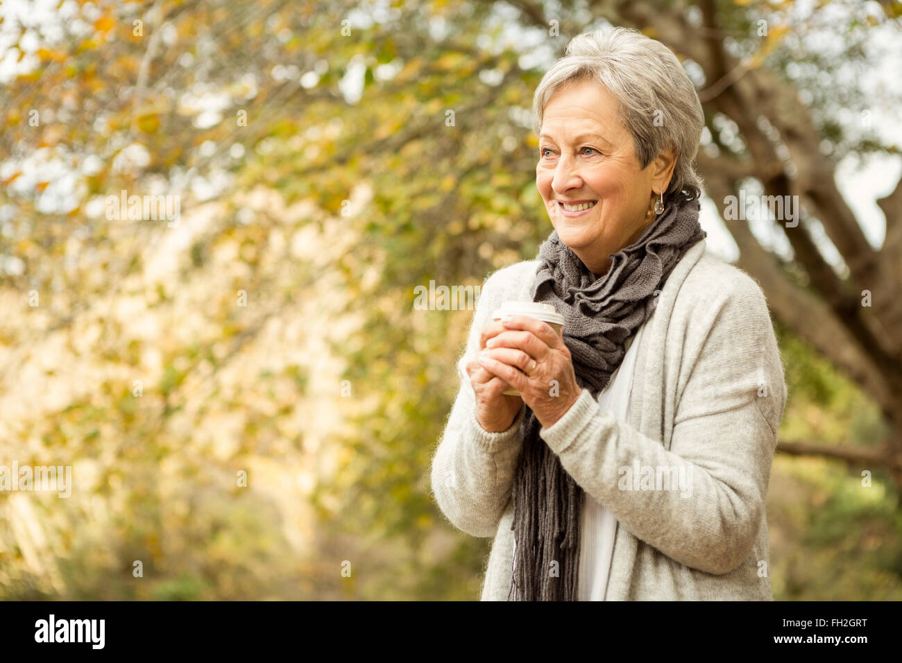 Senior woman in the park Stock Photo - Alamy