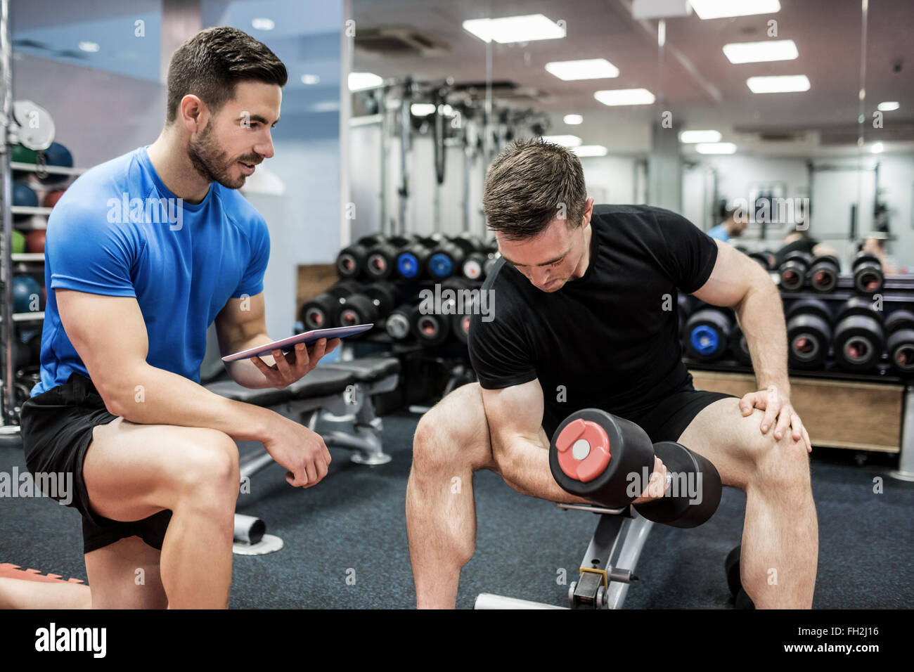 Fit man working out in weights room Stock Photo - Alamy