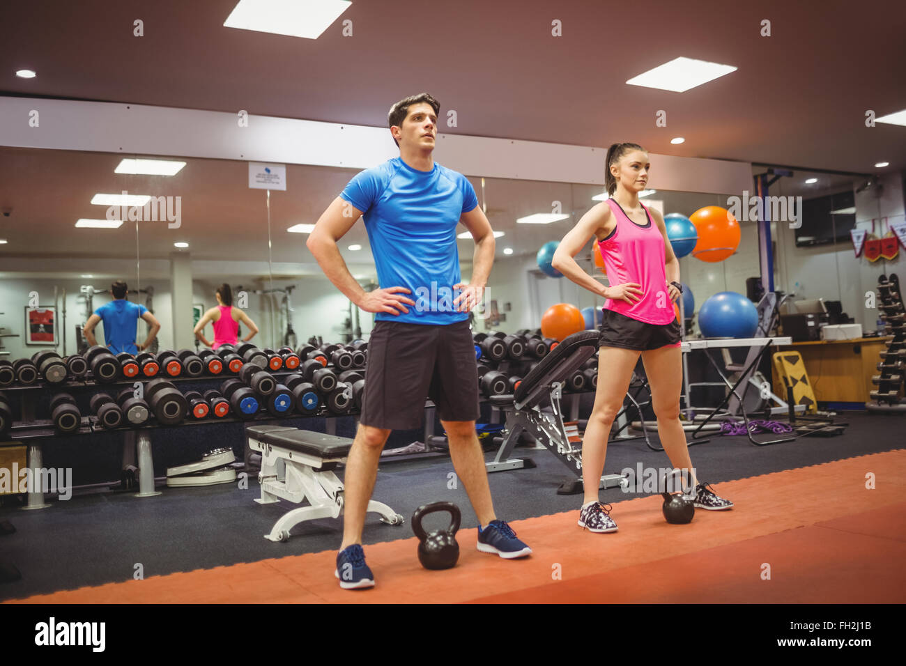 Fit couple working out in weights room Stock Photo - Alamy