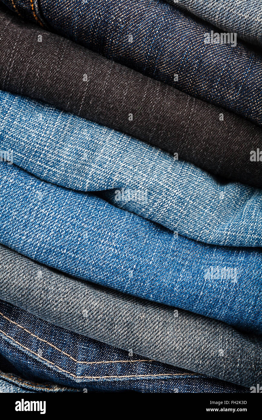 Stack of blue jeans as a background or texture Stock Photo - Alamy