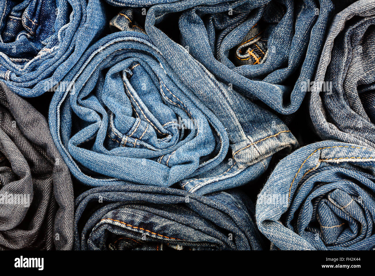 Stack of blue jeans as a background or texture Stock Photo - Alamy