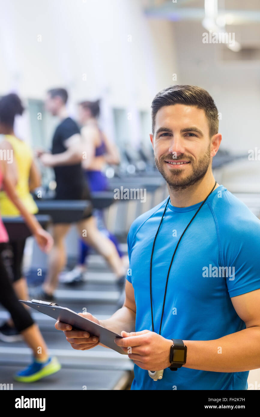 Handsome trainer smiling at camera Stock Photo - Alamy