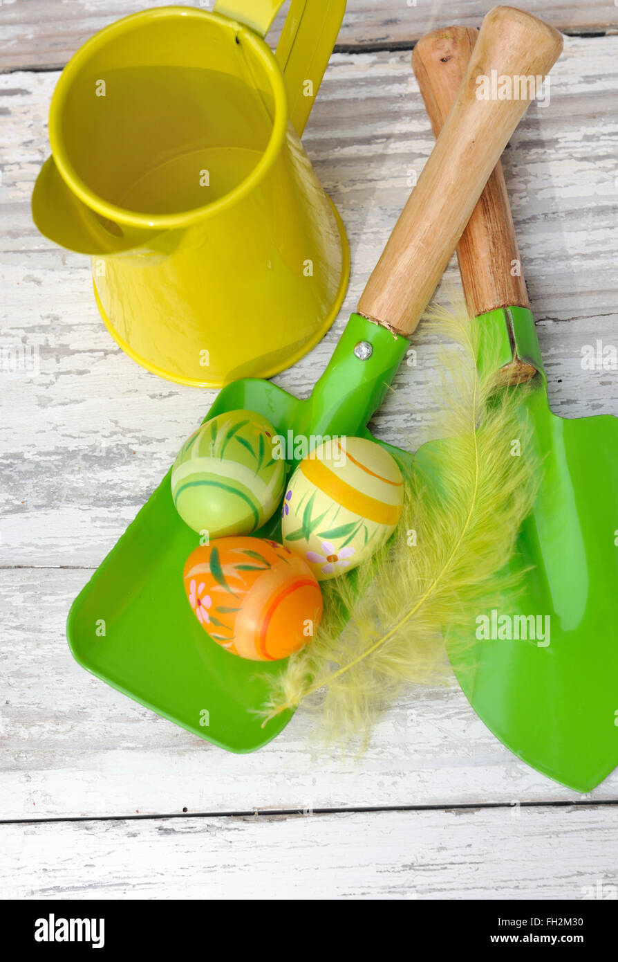 little gardening tools and easter eggs on white background Stock Photo ...
