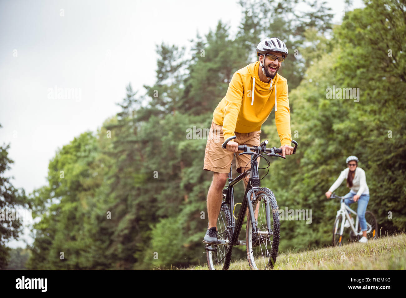 Happy couple on a bike ride Stock Photo - Alamy