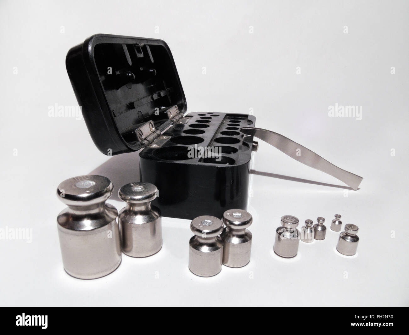 set of laboratory weights steel tweezers and the box for them Stock ...