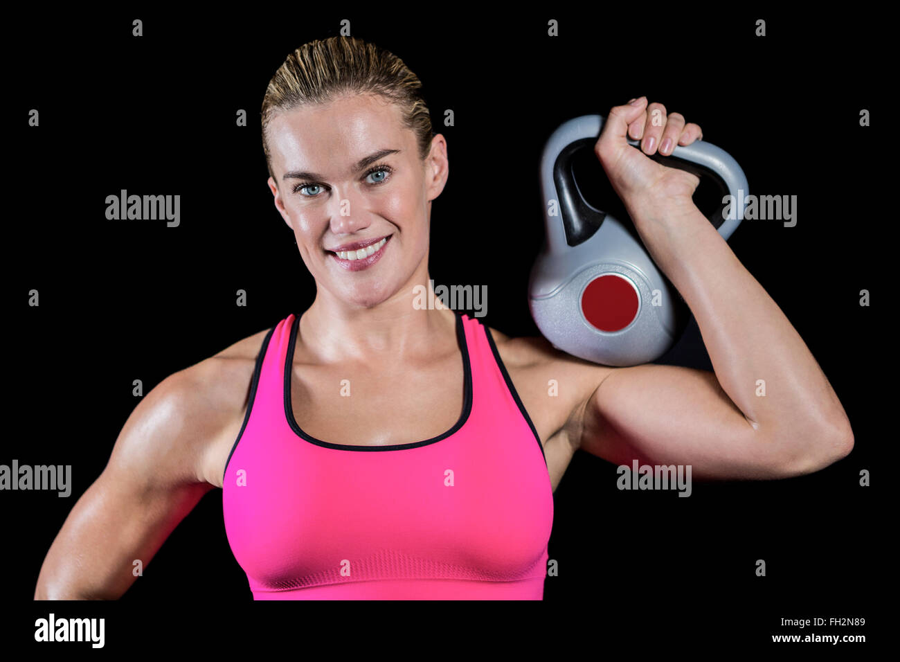Muscular woman lifting heavy kettlebell Stock Photo - Alamy