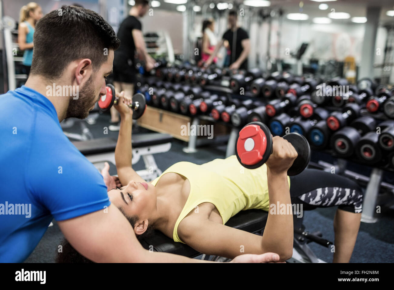 Fit people working out in weights room Stock Photo - Alamy