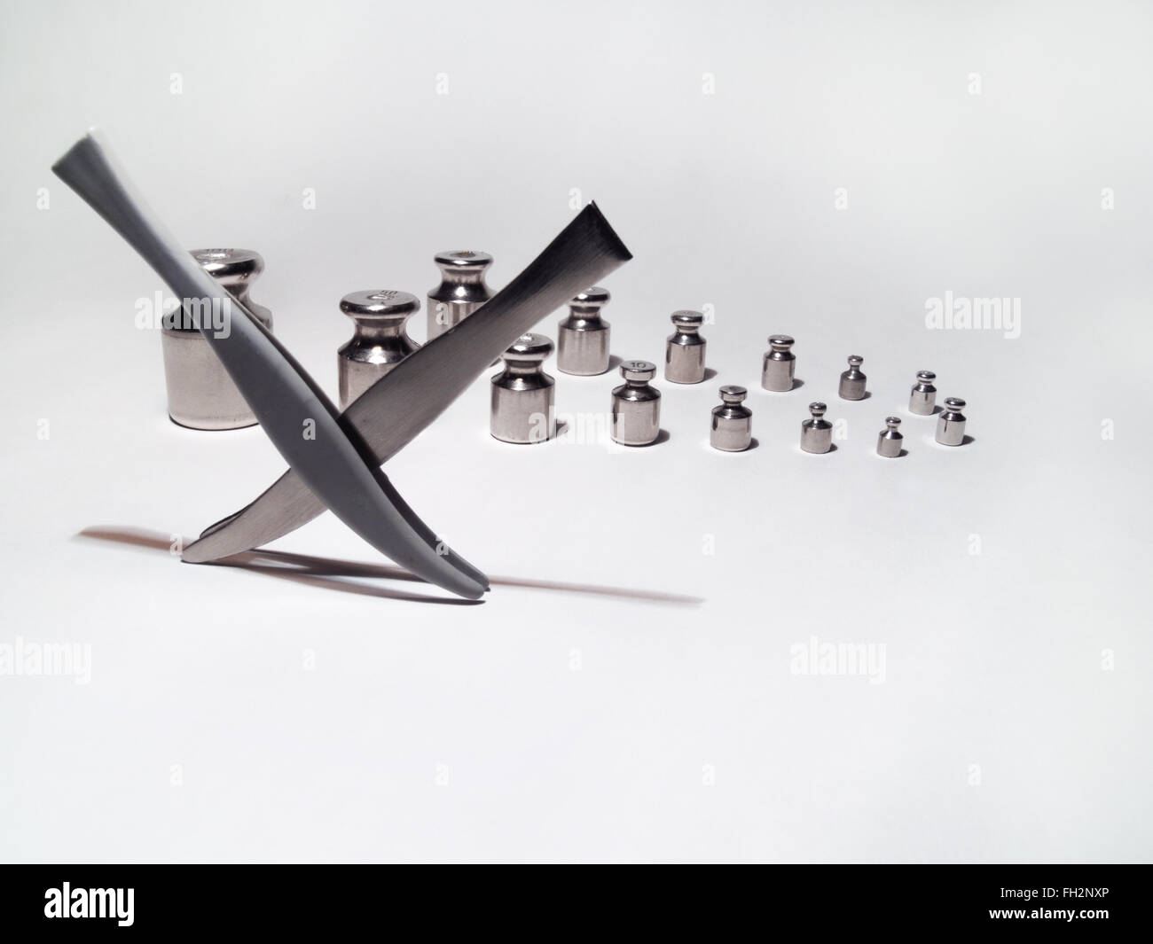 The set of laboratory weights, steel and plastic tweezers Stock Photo ...