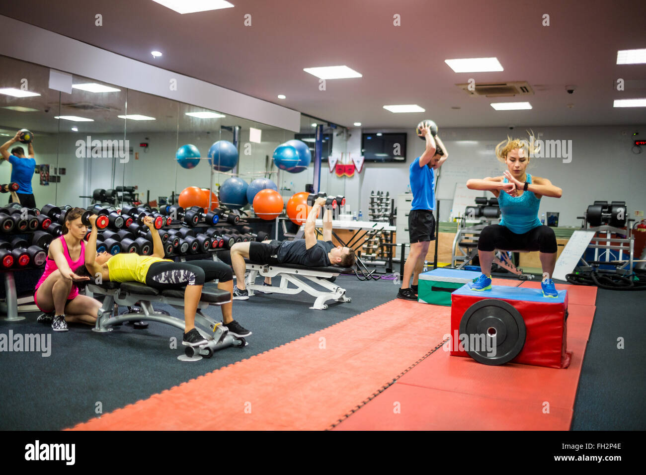 Fit people working out in weights room Stock Photo - Alamy