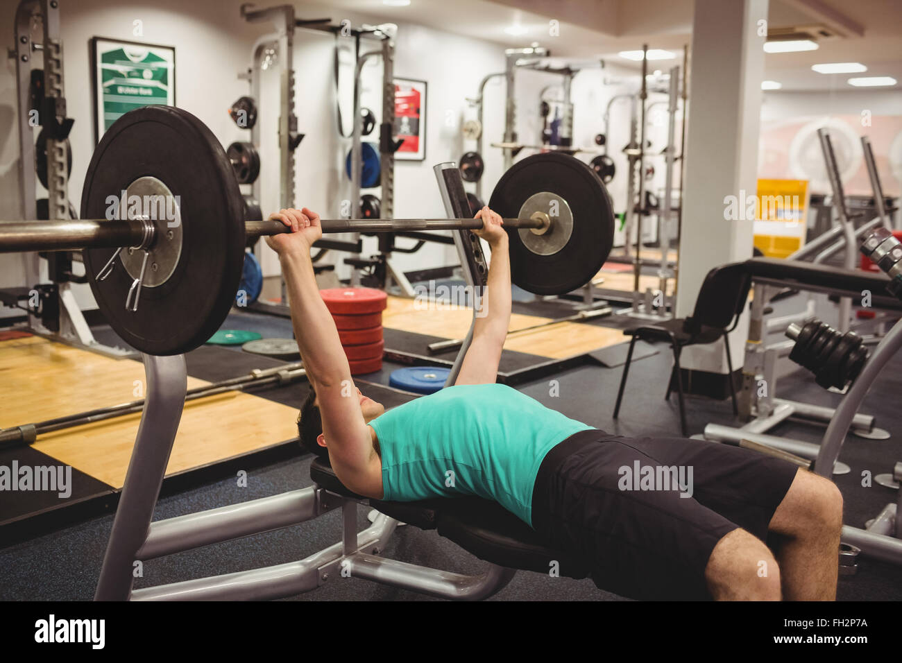 Fit man lifting heavy barbell Stock Photo - Alamy