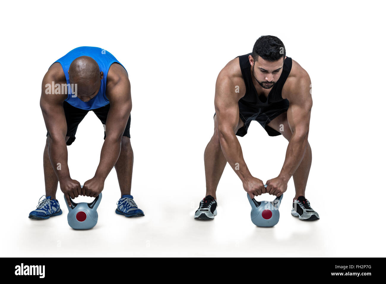 Strong friends lifting kettlebells together Stock Photo - Alamy