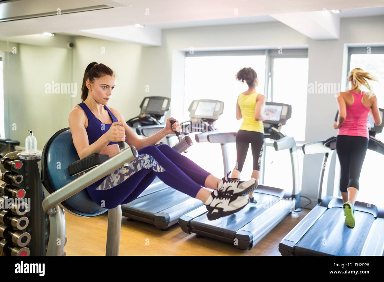 Fit people working out using machines Stock Photo - Alamy