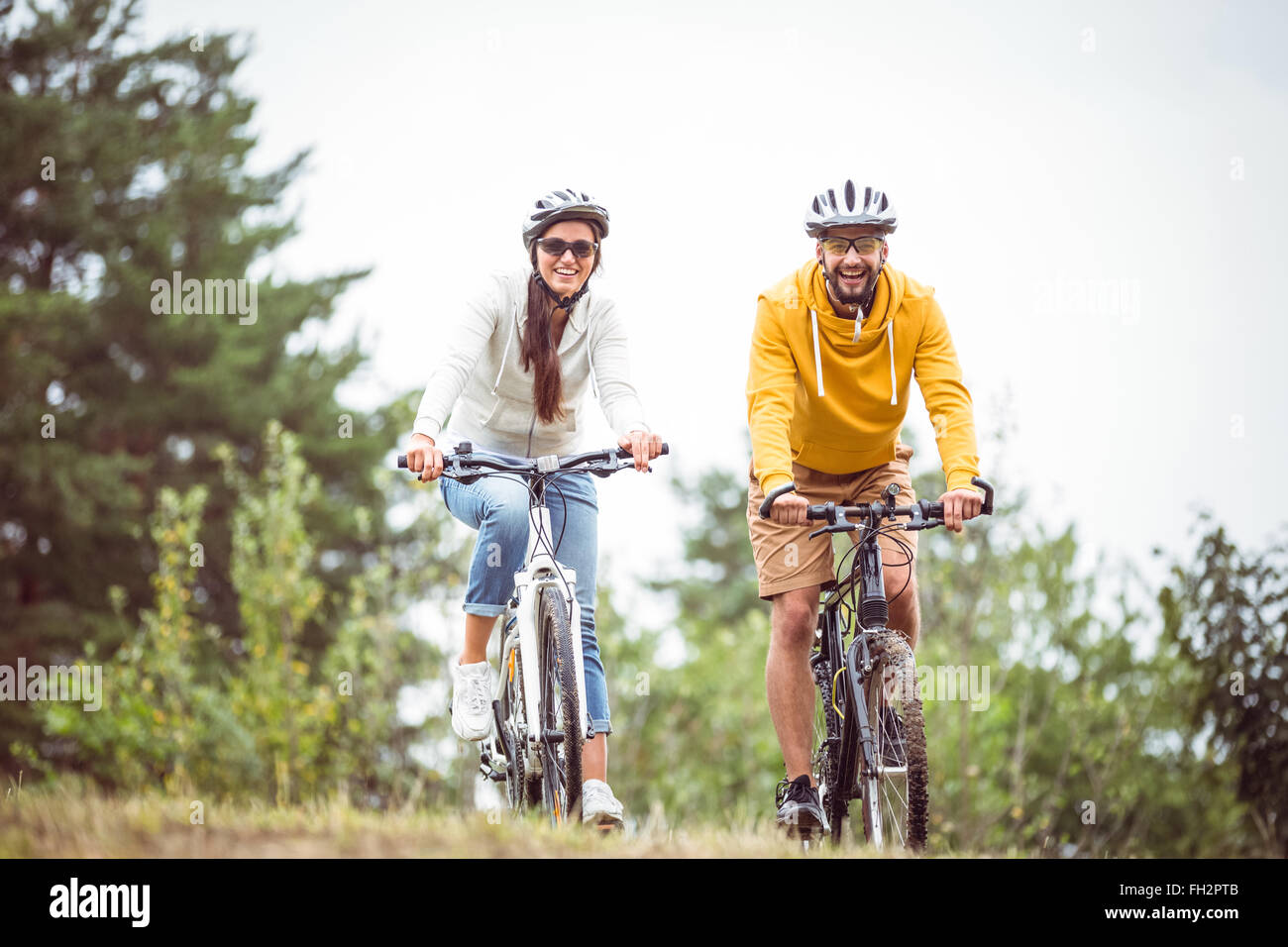 Happy couple on a bike ride Stock Photo - Alamy