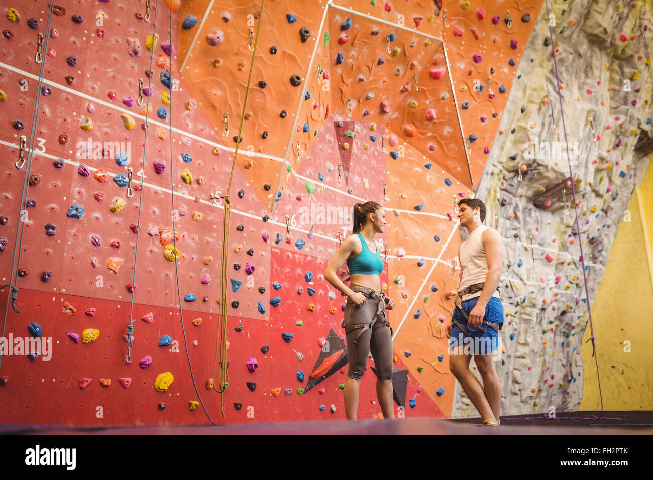 Fit couple at the rock climbing wall Stock Photo - Alamy
