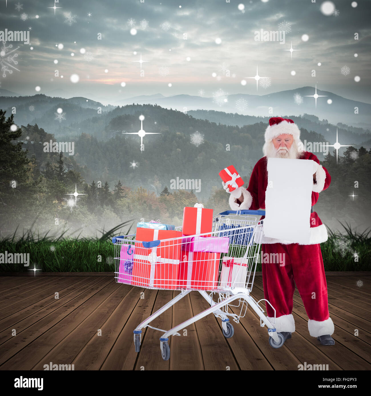 Composite image of santa delivering gifts from cart Stock Photo - Alamy