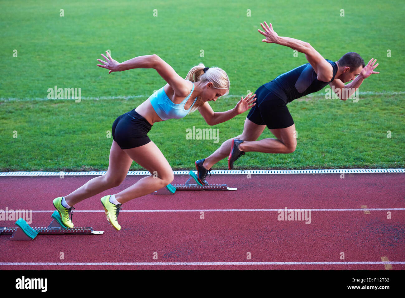 woman group running on athletics race track from start Stock Photo - Alamy
