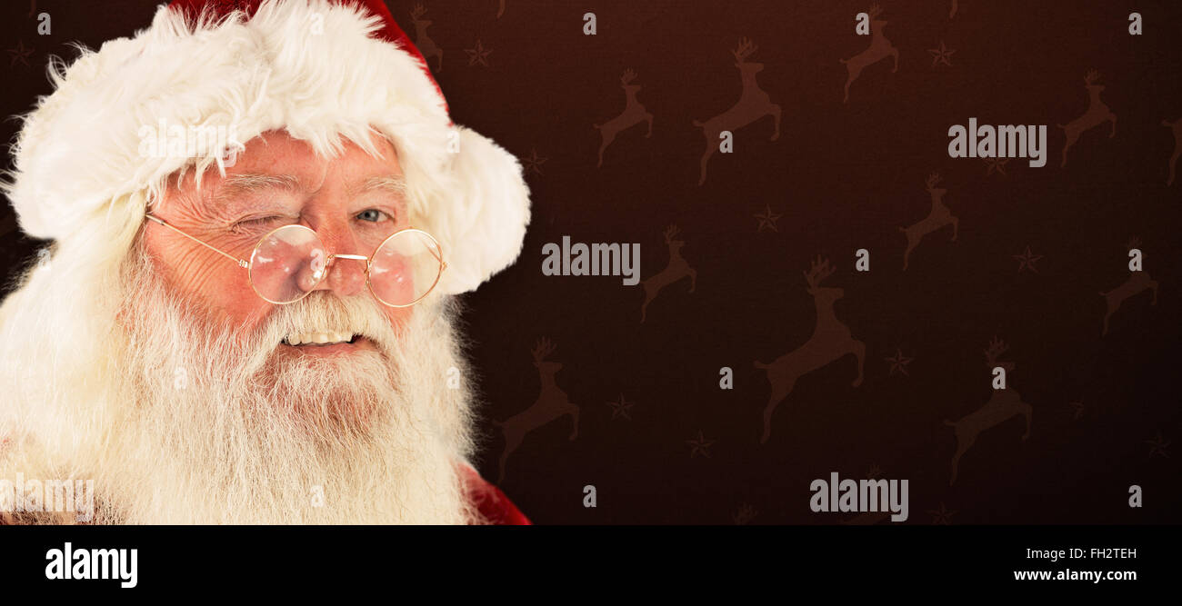 Composite image of santa claus winking Stock Photo - Alamy