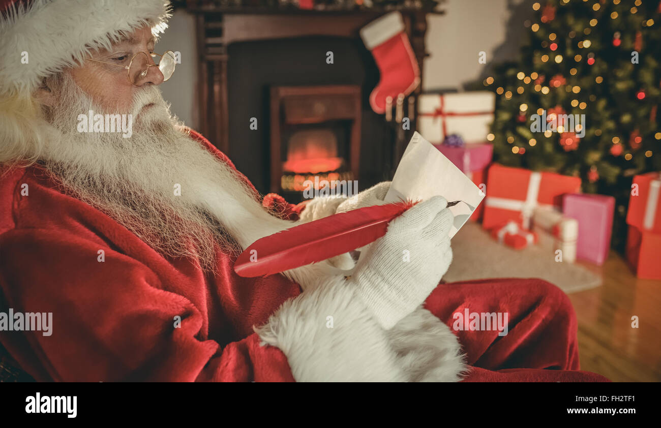Santa claus writing list on scroll Stock Photo - Alamy