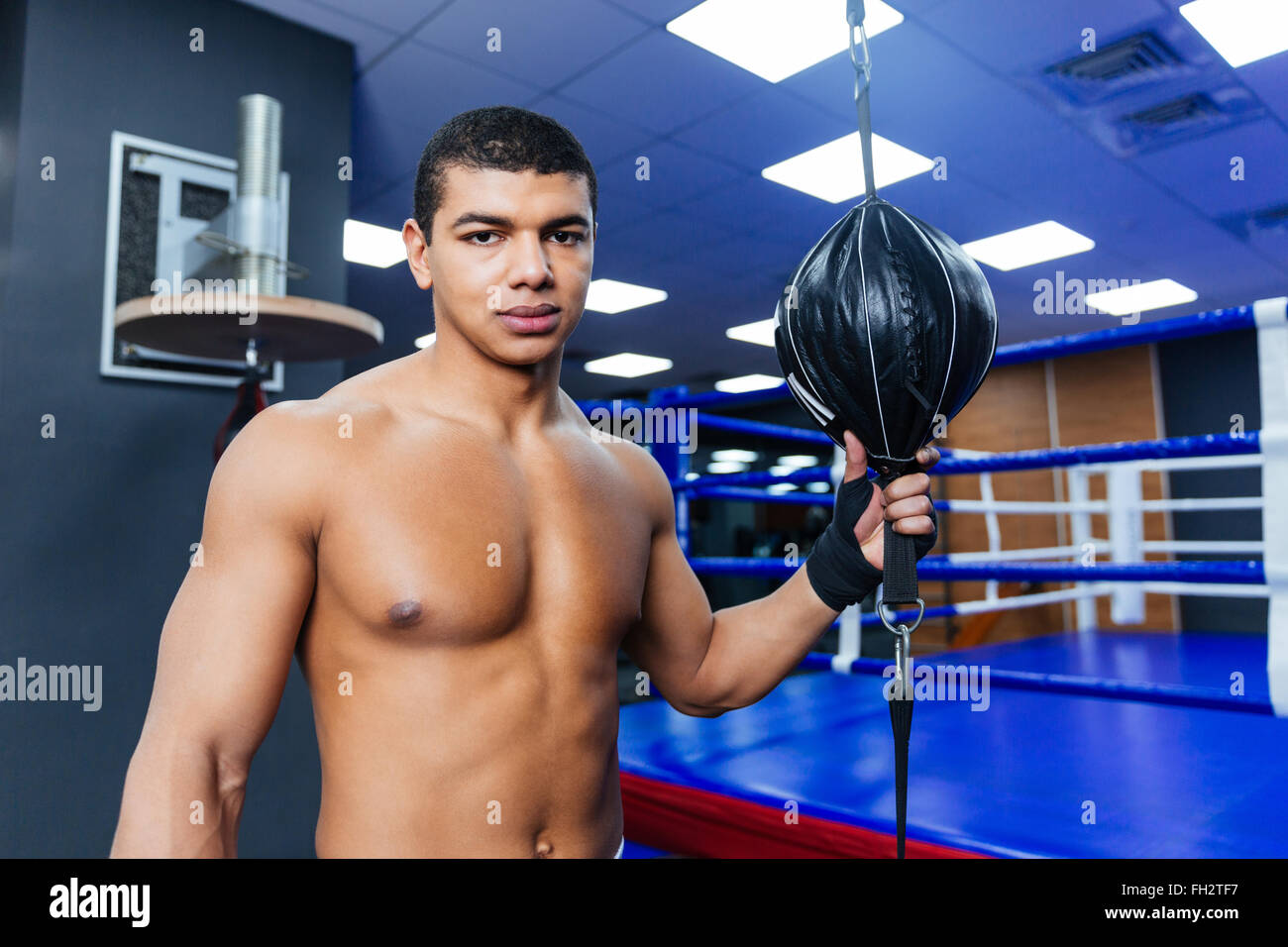 Male boxer standing in gym and looking at camera Stock Photo - Alamy