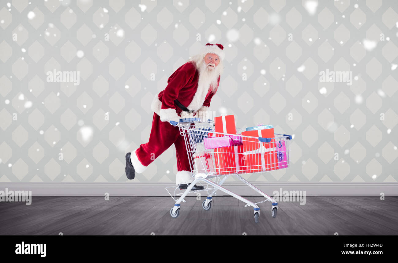 Composite image of santa pushing shopping cart Stock Photo - Alamy