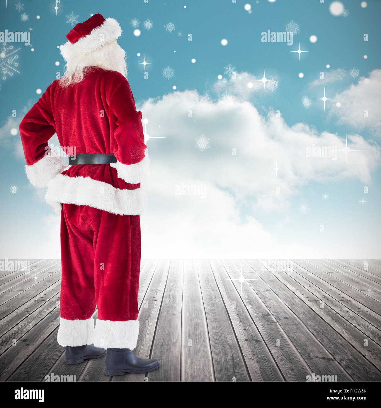 Composite image of santa with hands on hips Stock Photo - Alamy