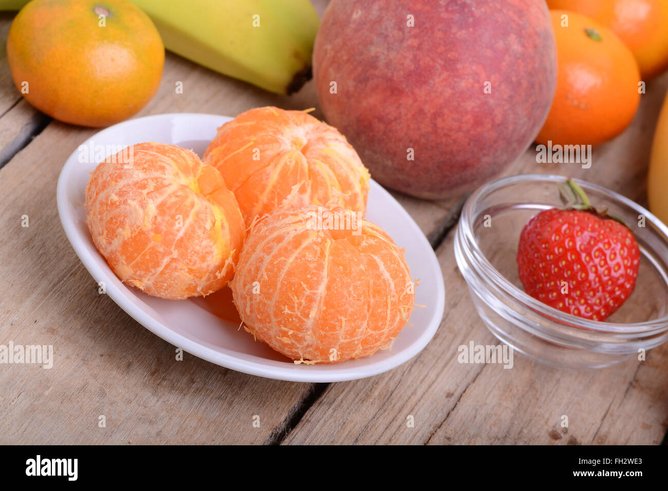Fresh colorful fruits composition mandarin, strawberry, peach, bananas ...
