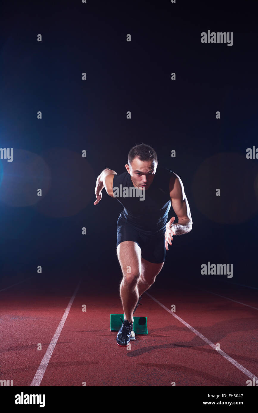 Sprinter leaving starting blocks Stock Photo - Alamy