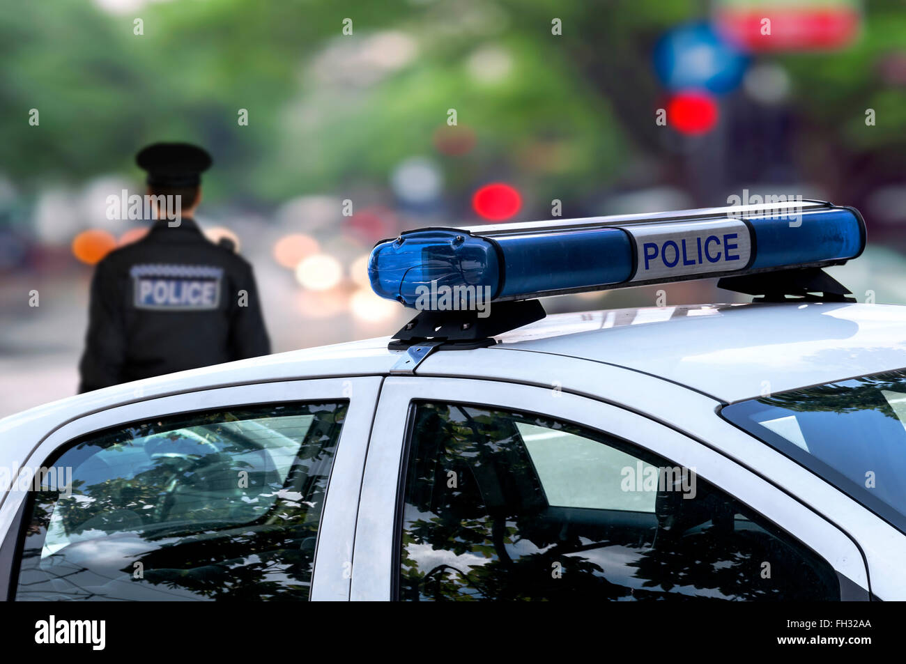 Police officer emergency service car driving street Stock Photo - Alamy