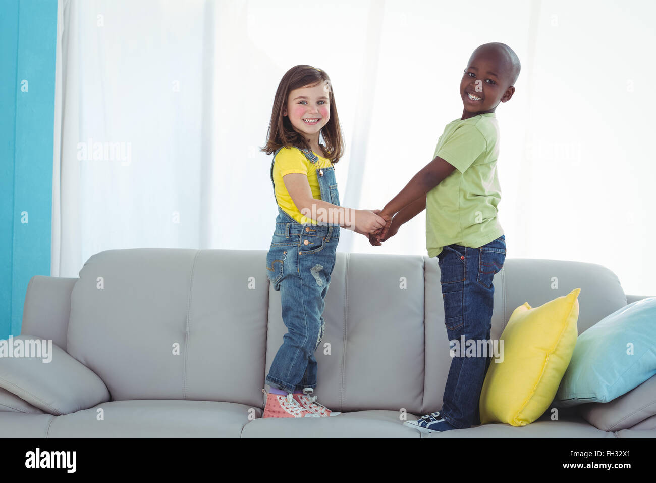 Happy boy and girl standing up Stock Photo - Alamy