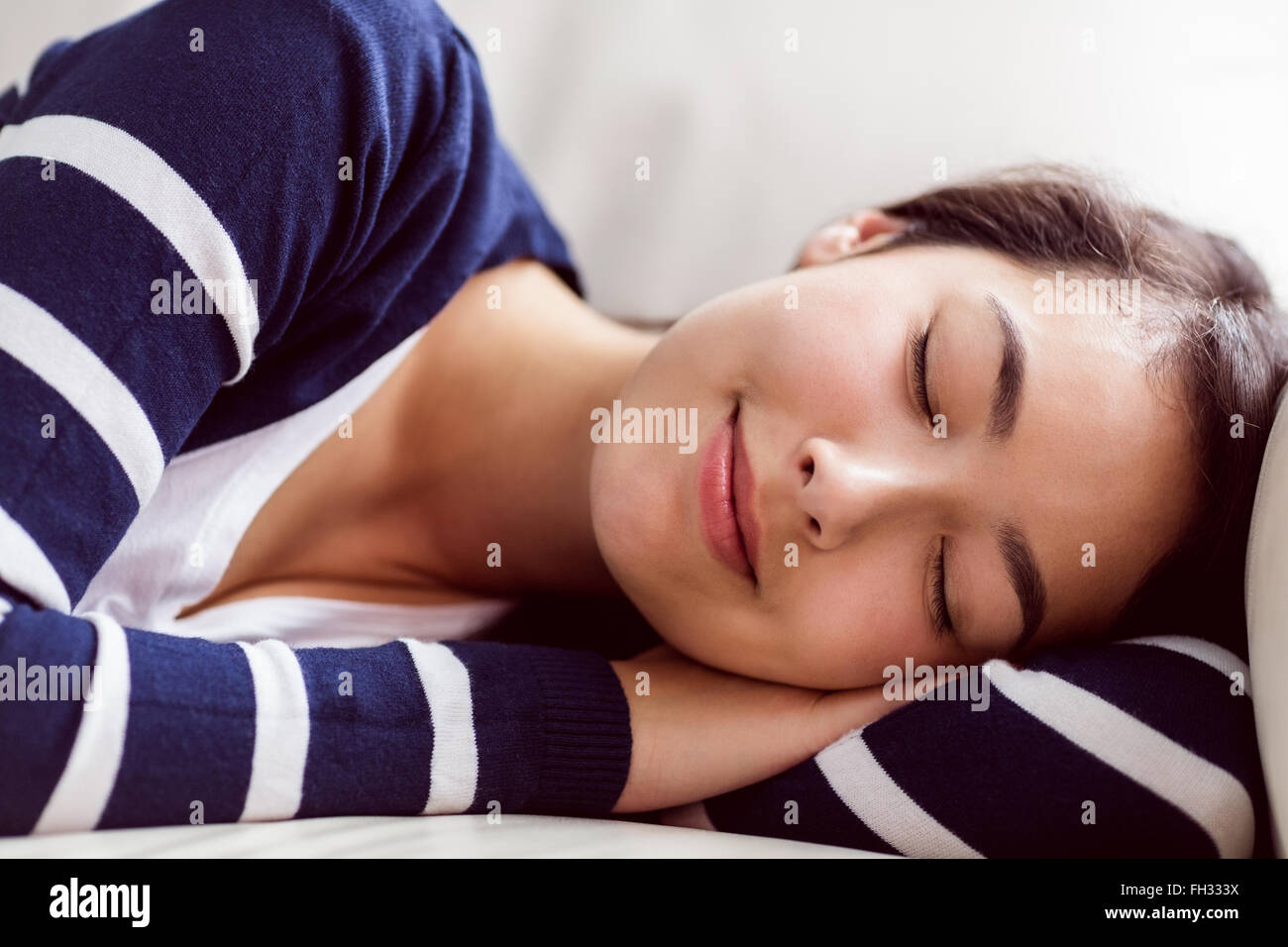 Asian woman napping on the couch Stock Photo - Alamy