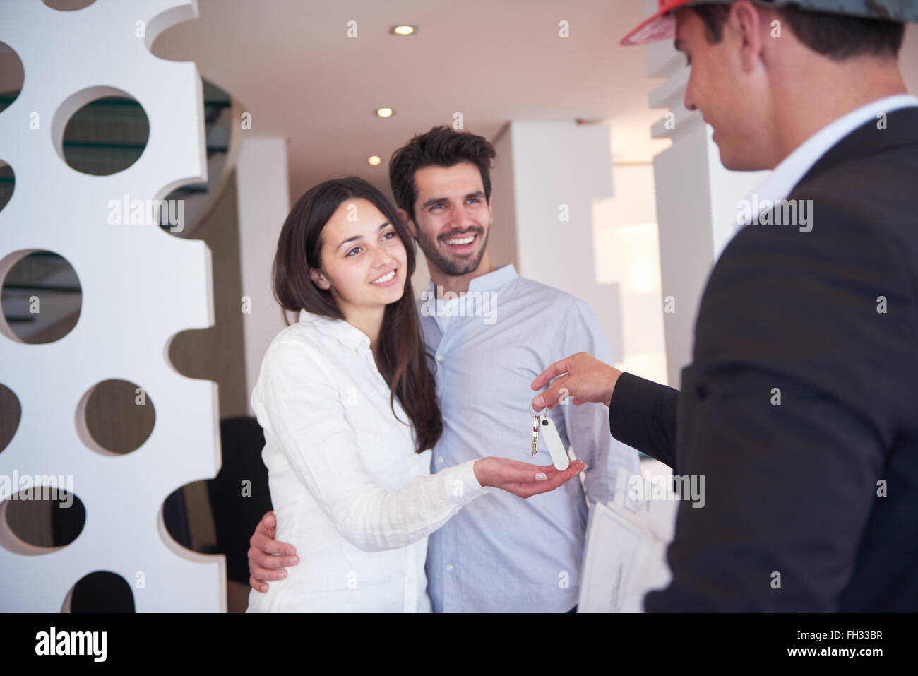 couple buying new home with real estate agent Stock Photo - Alamy