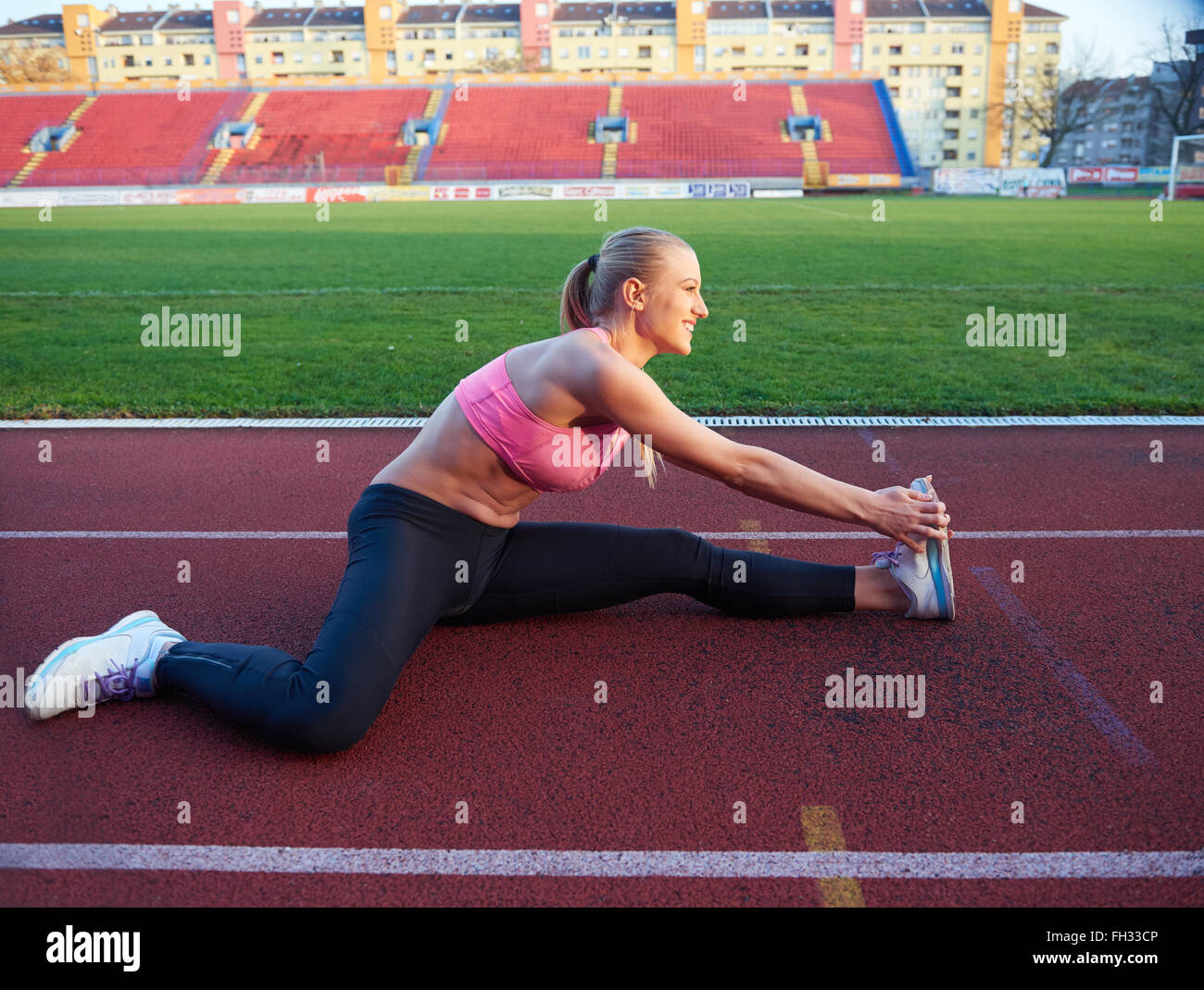 sporty woman on athletic race track Stock Photo - Alamy
