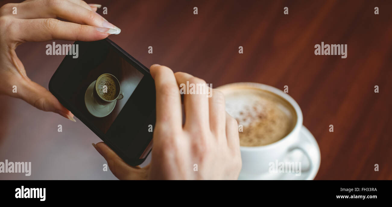 Woman taking a photo of her coffee Stock Photo - Alamy