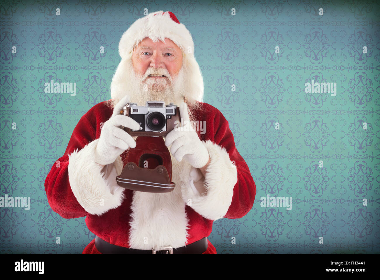 Composite image of santa is taking a picture Stock Photo - Alamy